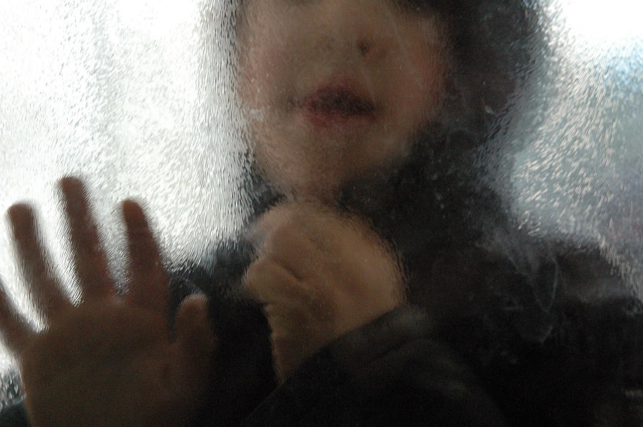 Boy behind glass by Matthias Hauser