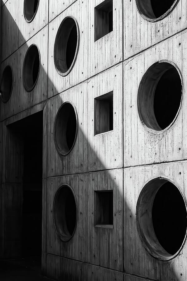 Brutalist Concrete Facade With Circular Windows by Matthias Hauser